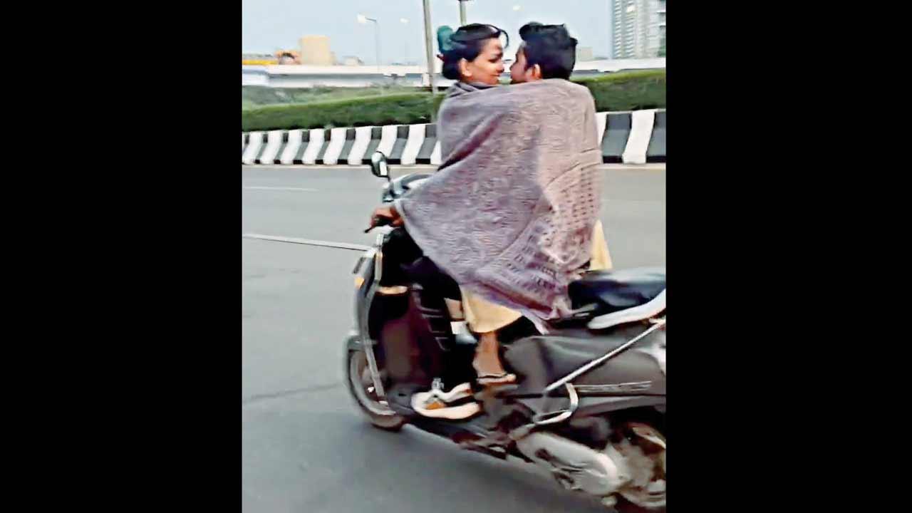 A couple spotted on a scooter in a tight embrace on Reclamation Road in ...